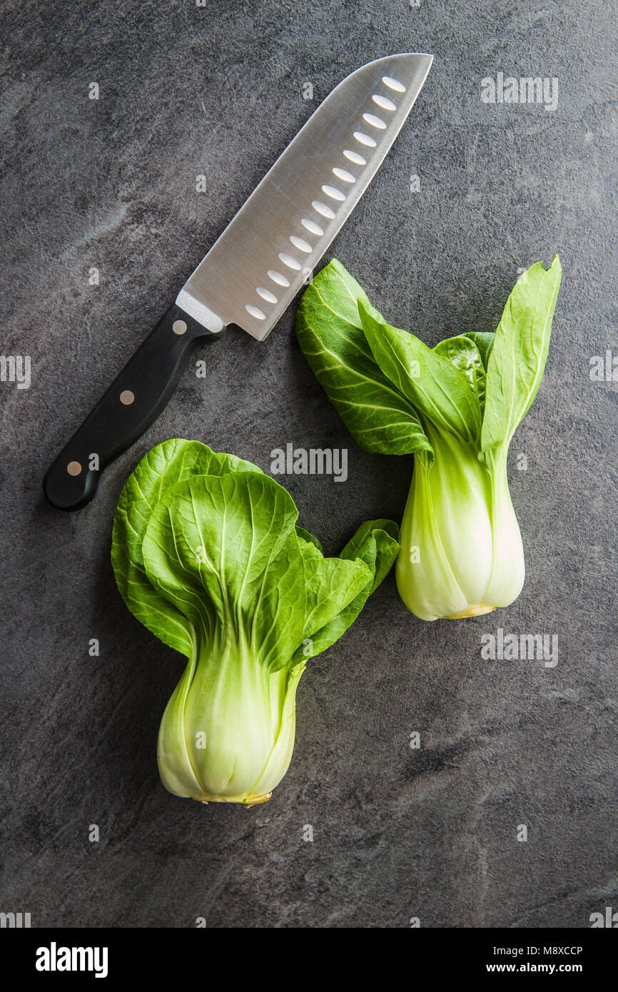 Fresh pak choi cabbage on black table Stock Photo - Alamy