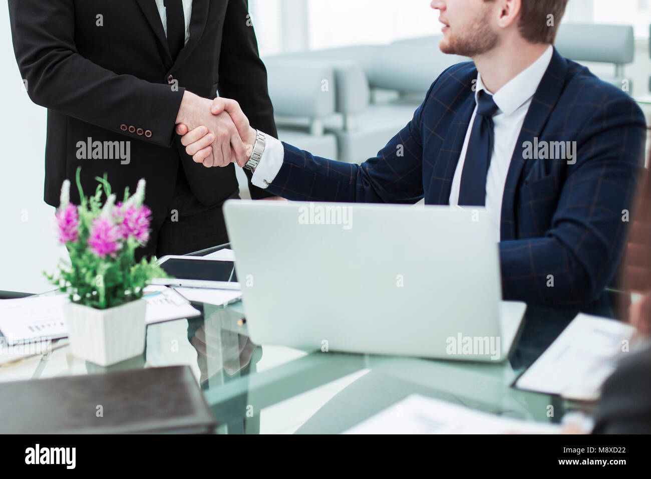 handshake between colleagues in the workplace in a modern office Stock ...