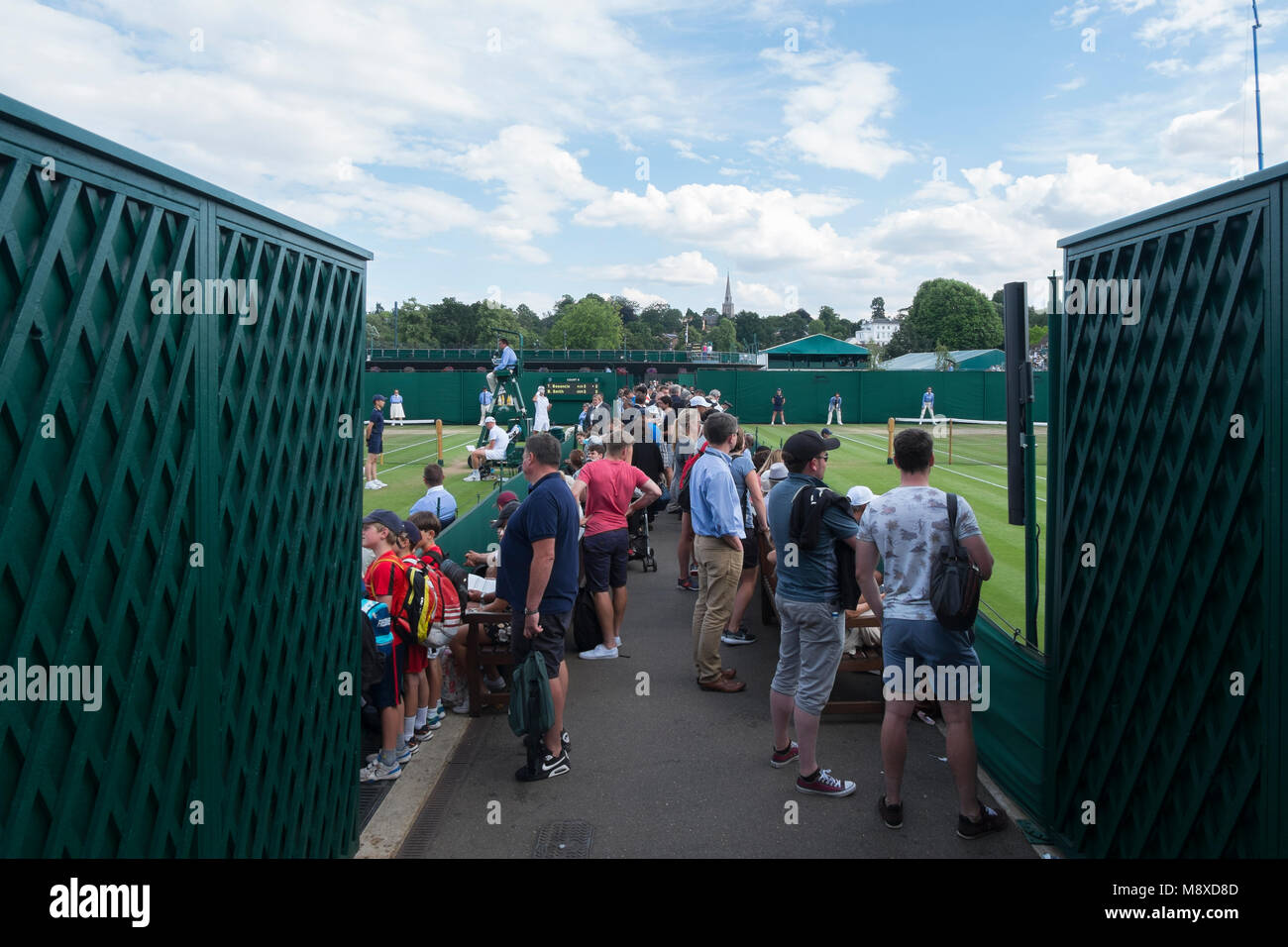 Spectators watching matches on the outside courts at the Wimbledon ...