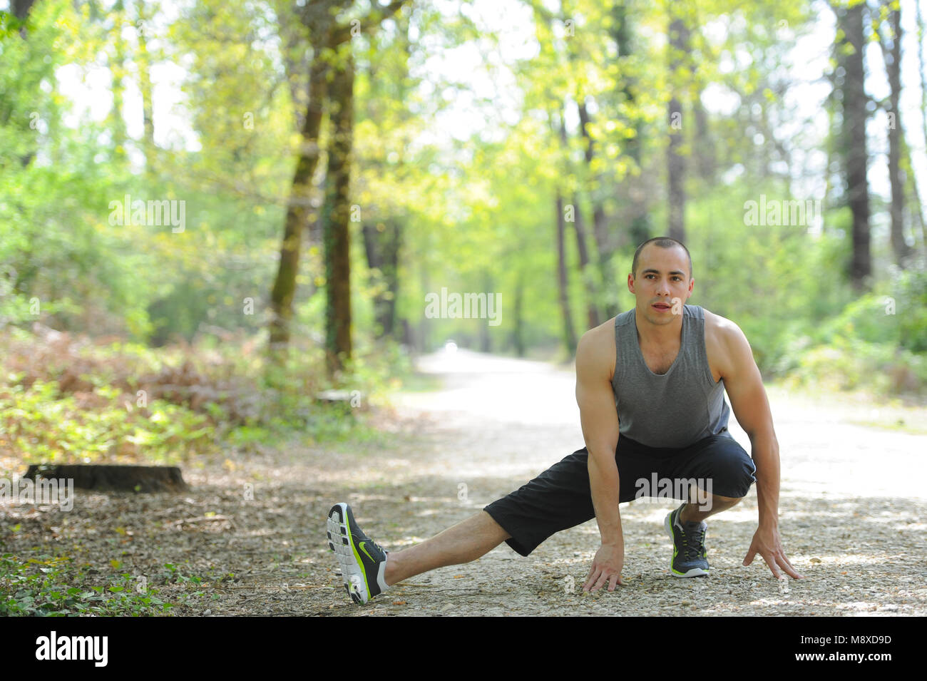 Stretching Young man Sport Fitness France forest spring Stock Photo - Alamy
