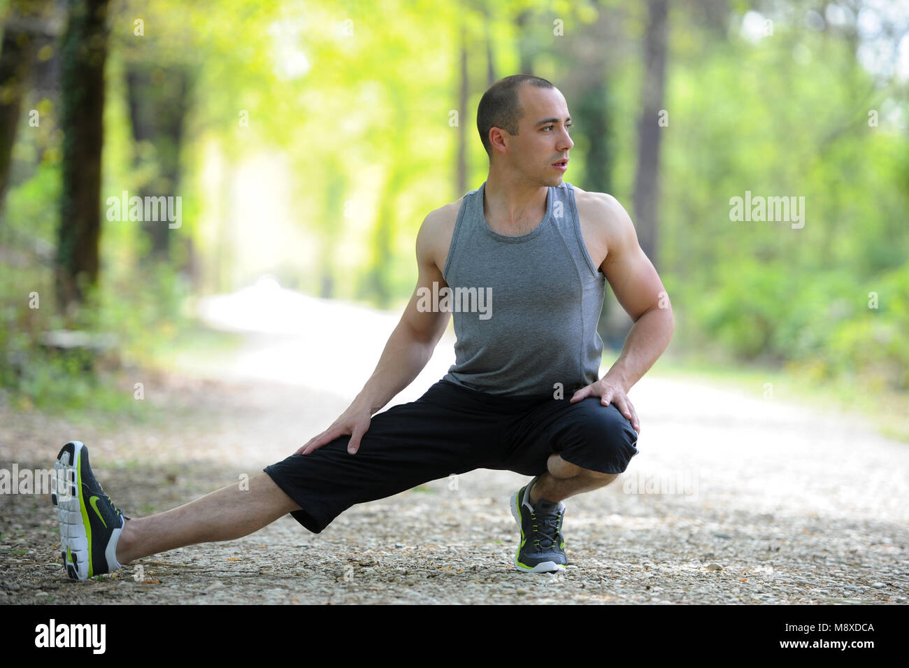 Stretching Young man Sport Fitness France forest spring Stock Photo - Alamy