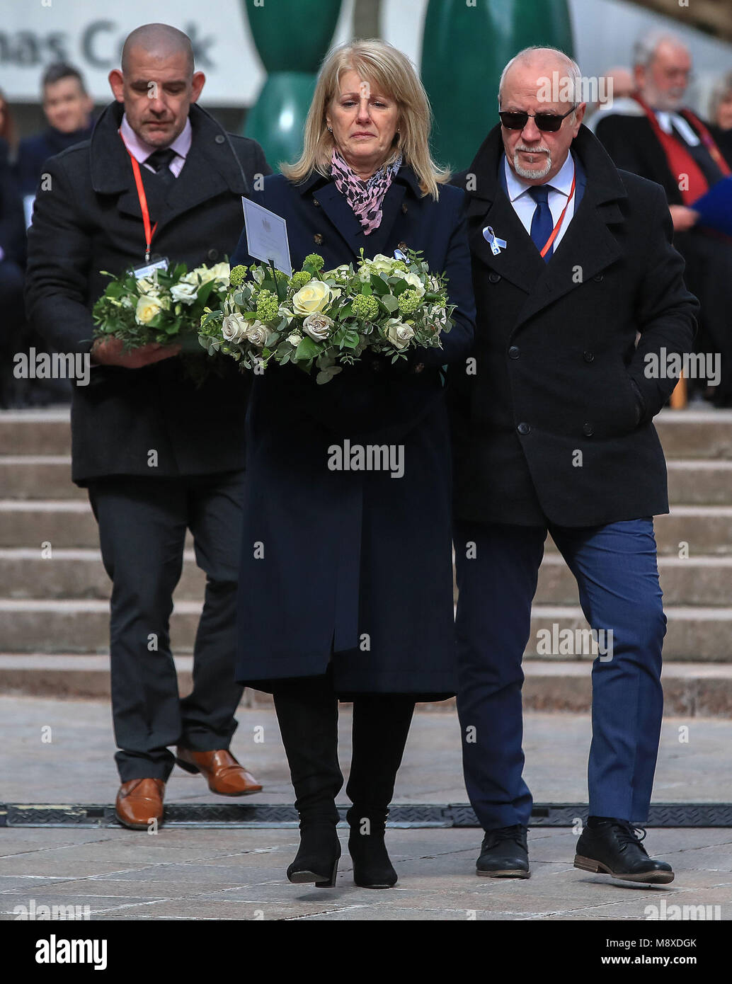 Wendy Parry and her husband Colin (right) lay flowers at the memorial ...