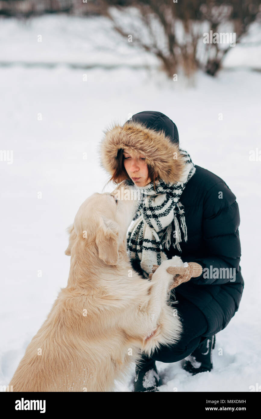 Photo of labrador giving paw to girl in winter park Stock Photo - Alamy