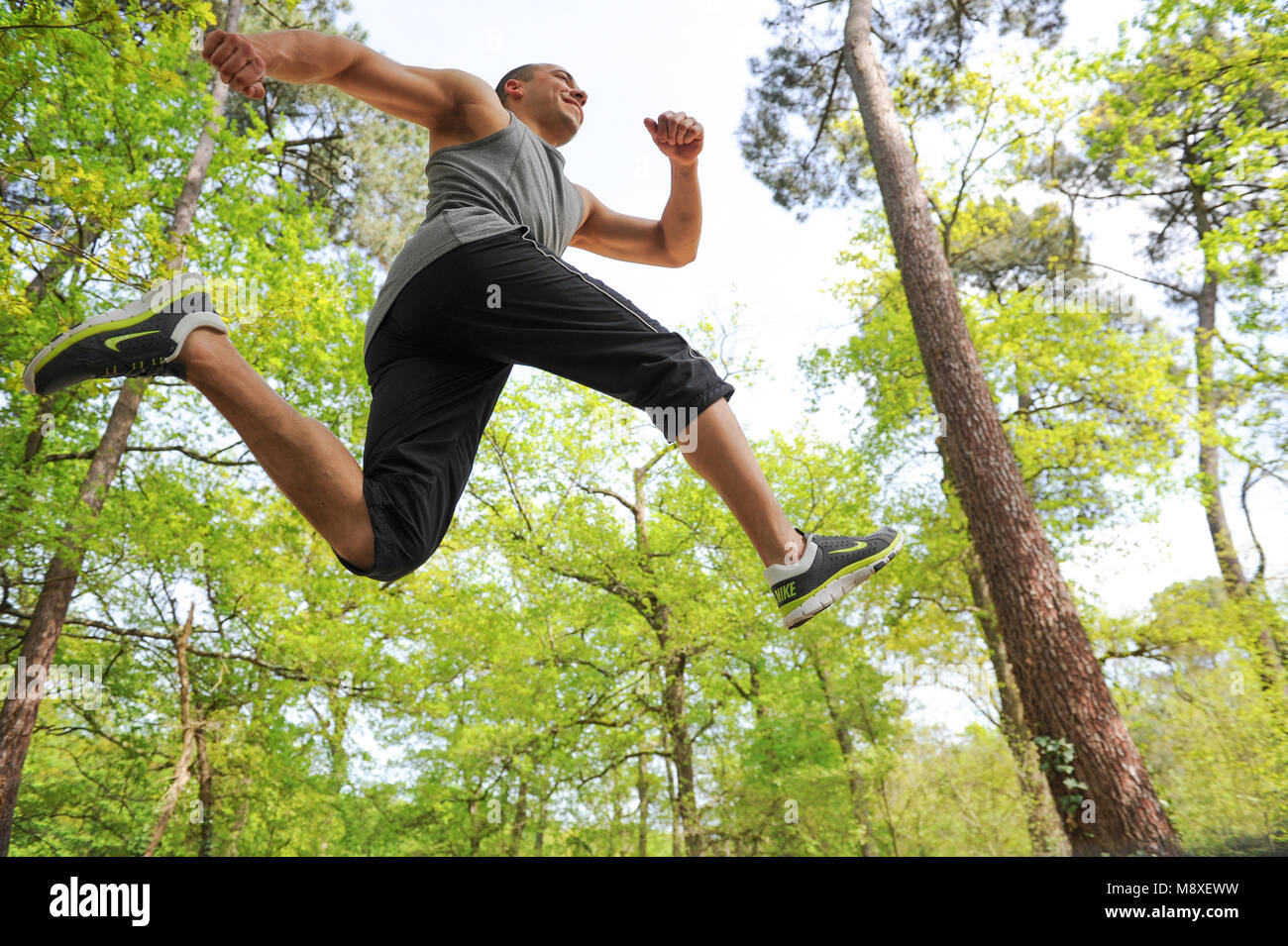 Athletic man jumping in forest, France, Sport Stock Photo - Alamy