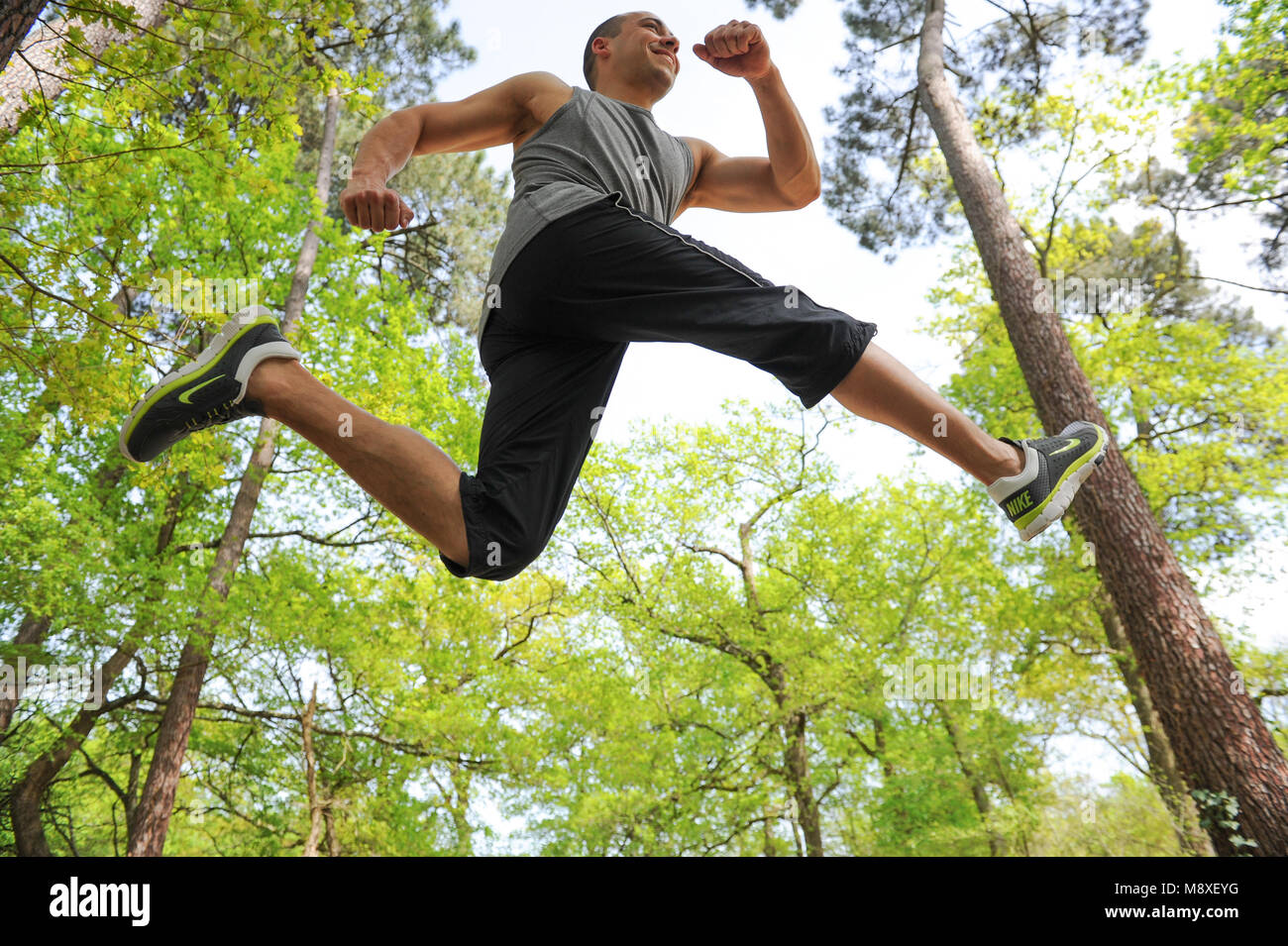 Athletic man jumping in forest, France, Sport Stock Photo - Alamy