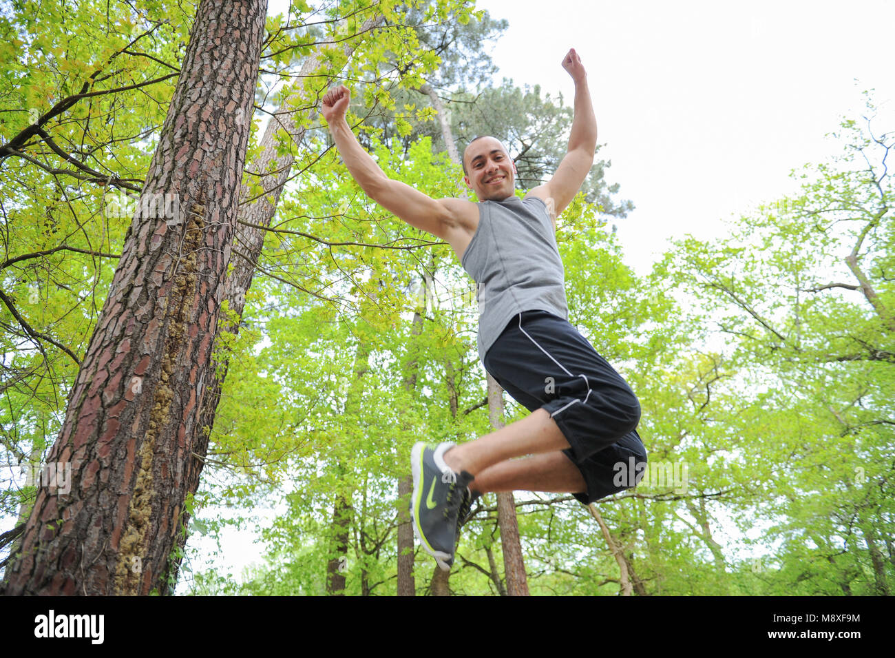 Athletic man jumping in forest, France, Sport Stock Photo - Alamy