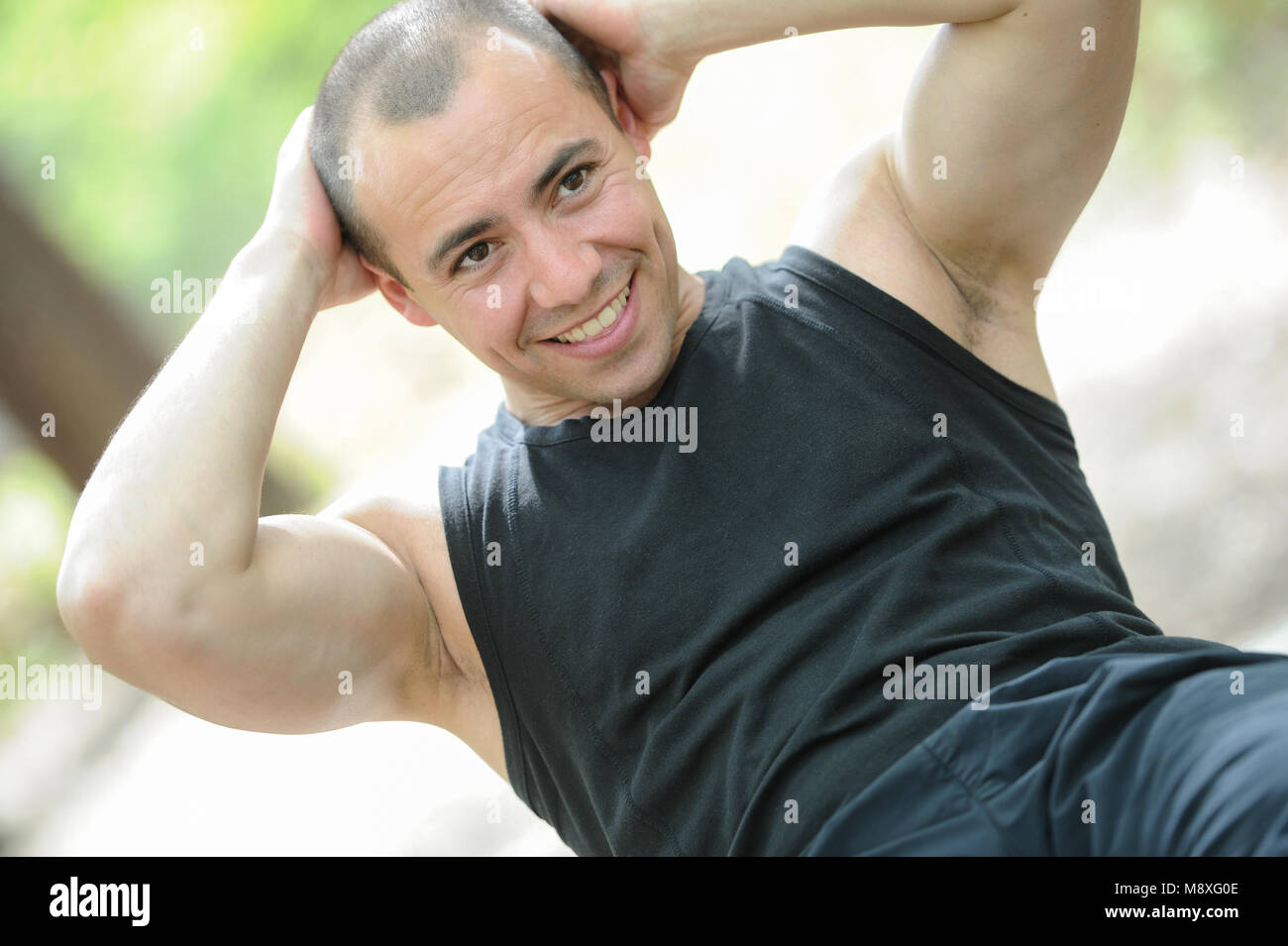 Young man muscular doing abs Stock Photo - Alamy
