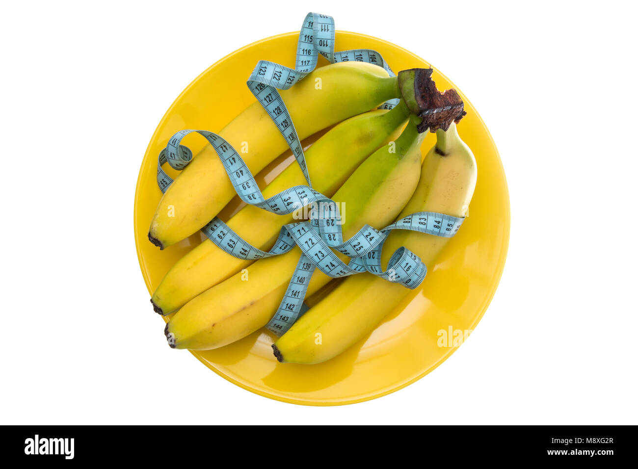 Bunch of banana fruits and measuring tape on the plate. Healthy dieting ...