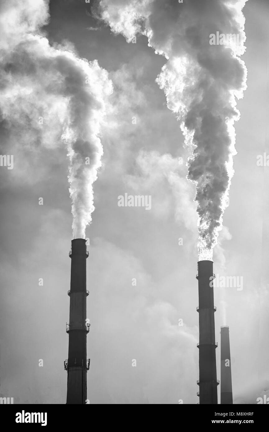 Factory chimneys smoke in cloudy sky Stock Photo - Alamy