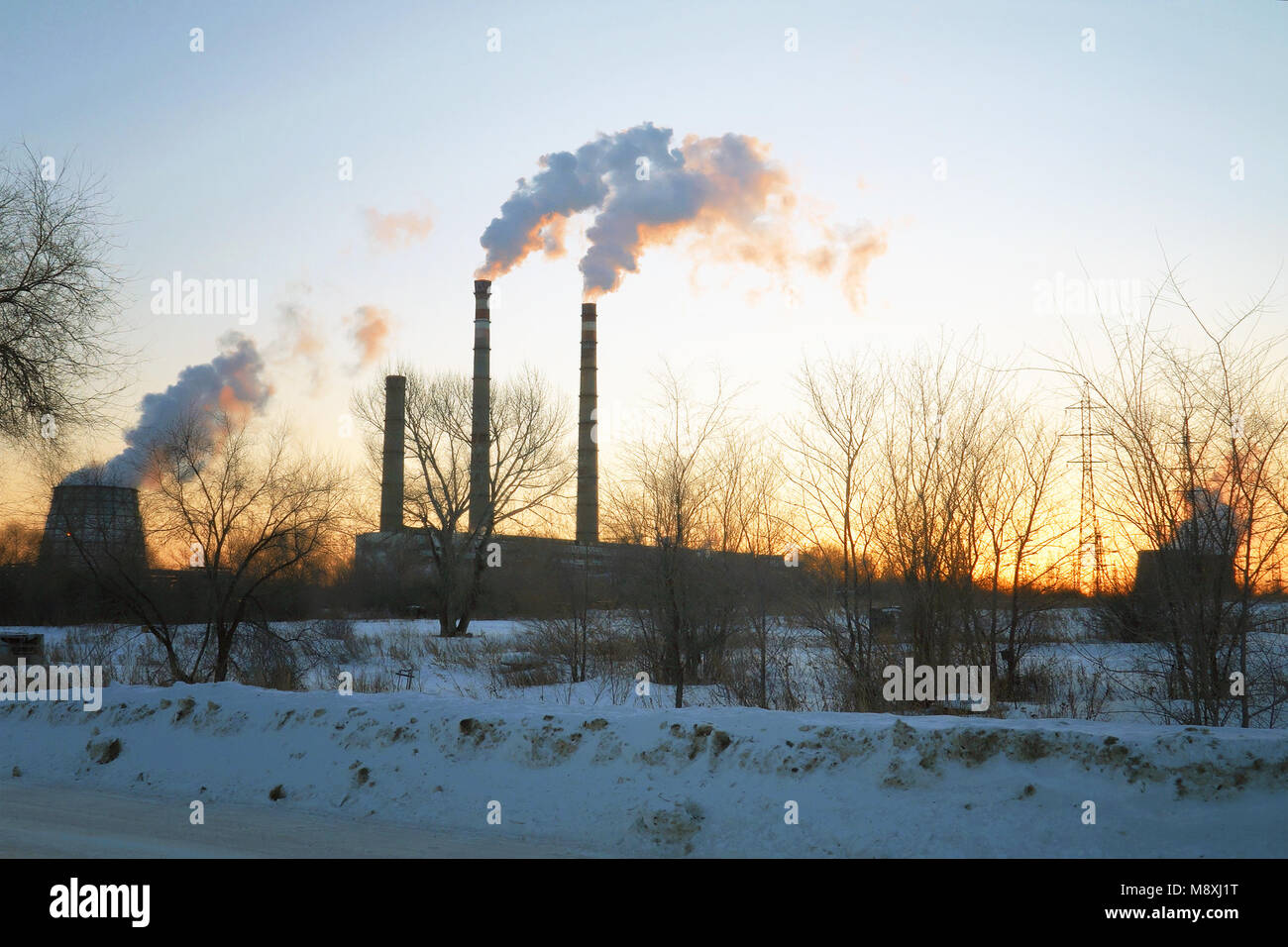 Smoke from factory chimneys on sunset sky Stock Photo - Alamy