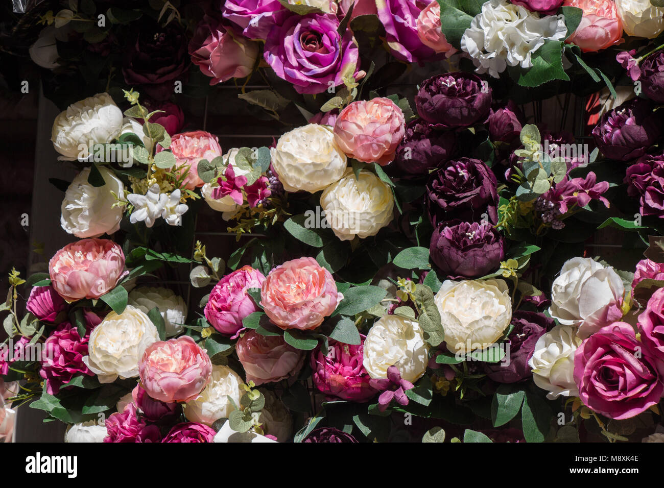 Colorful fake artificial flowers in view Stock Photo - Alamy
