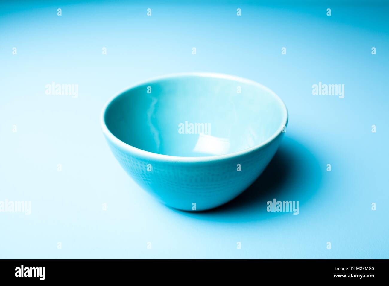 Empty blue bowl Stock Photo - Alamy