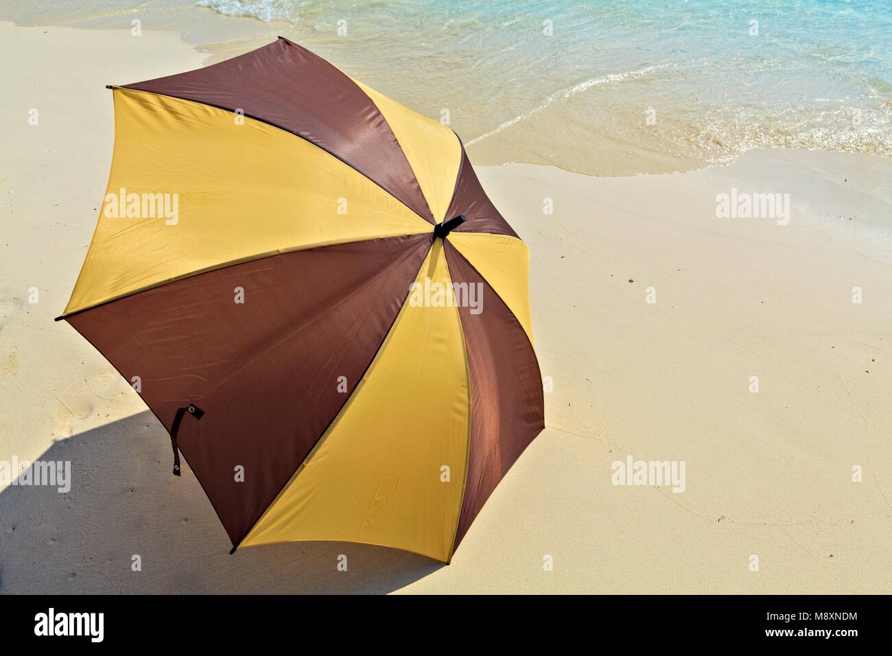 Opened umbrella is on the ocean beach Stock Photo - Alamy