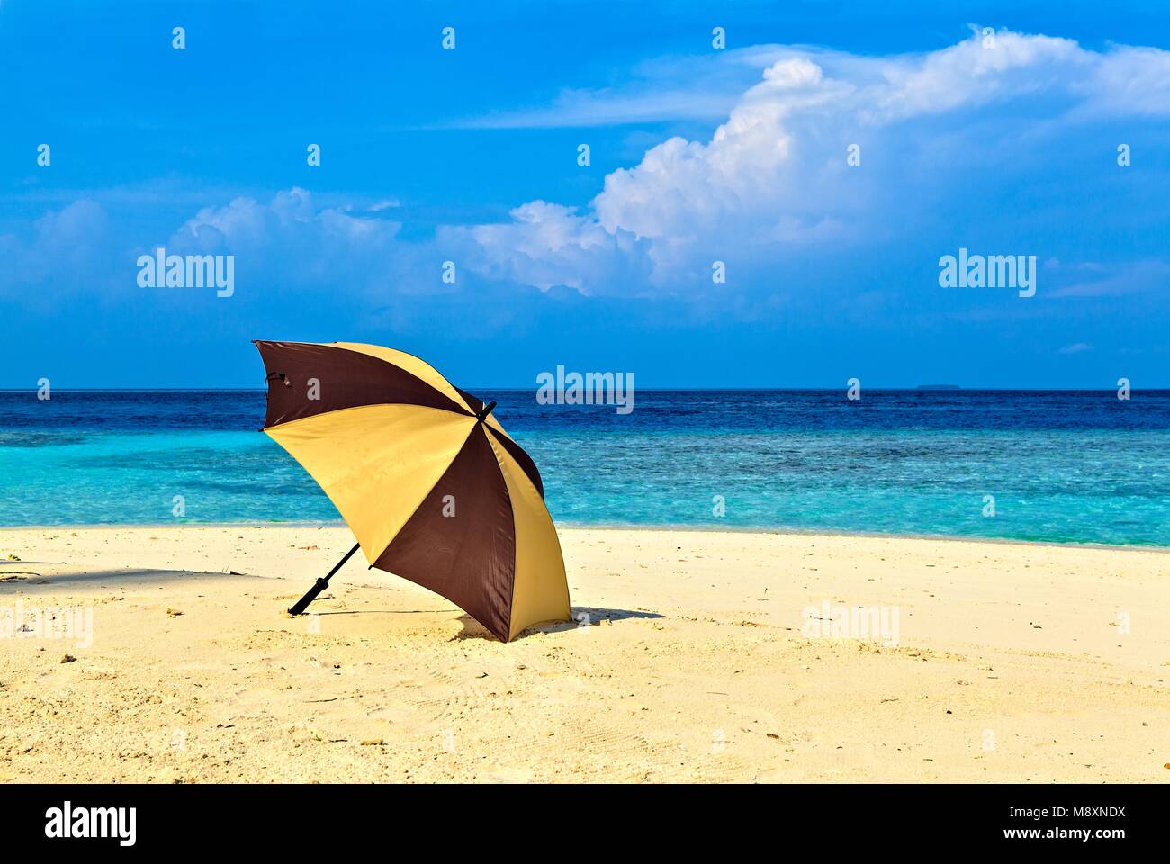 Opened umbrella is on the ocean beach Stock Photo - Alamy