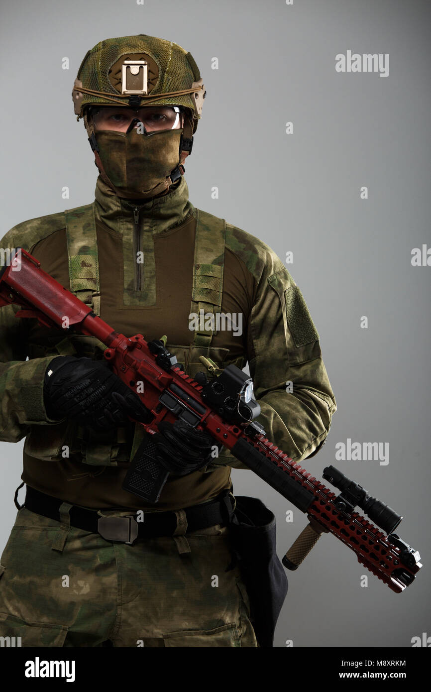 Portrait of military man with gun Stock Photo - Alamy