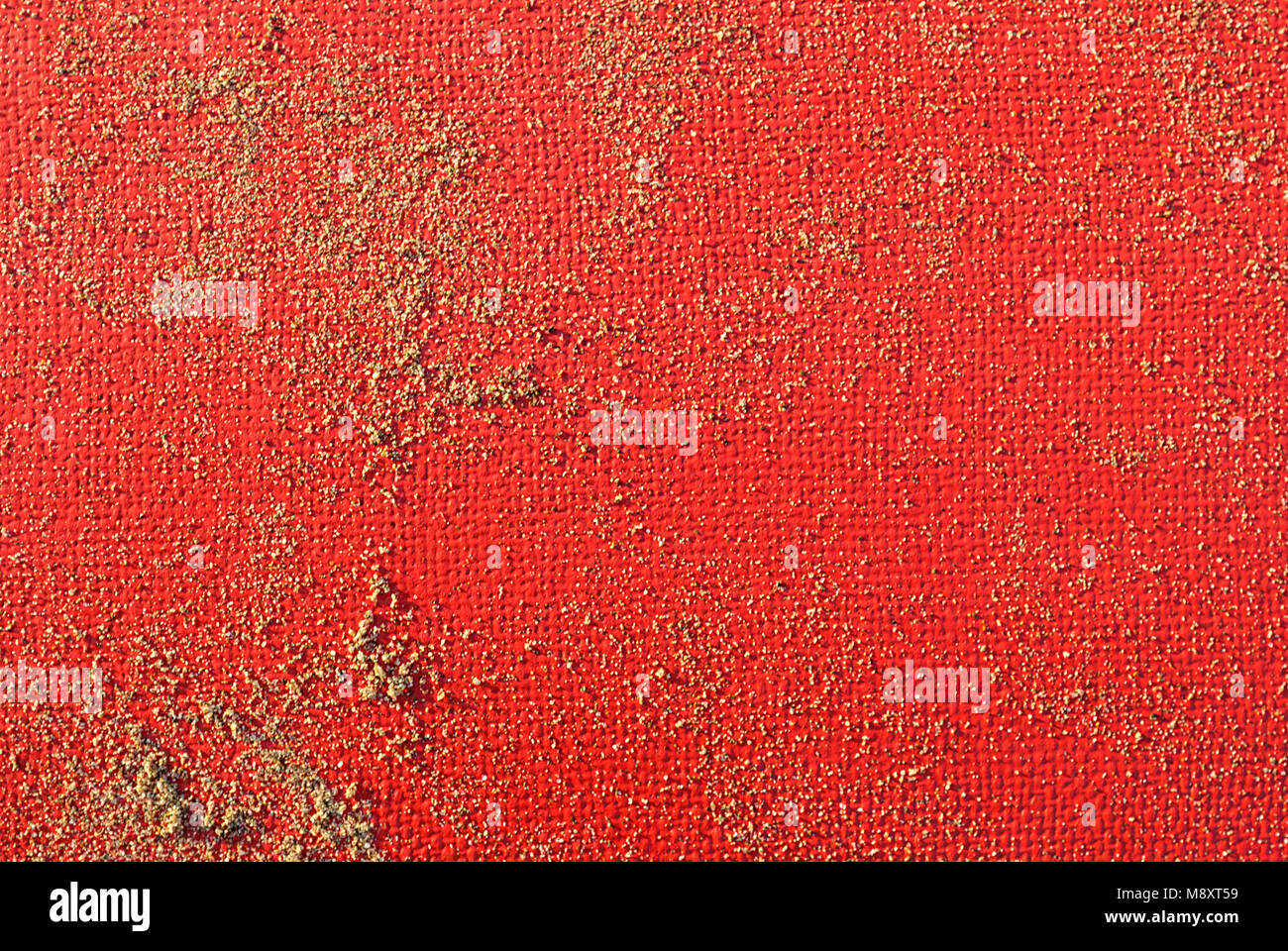 summer sea, red background for summer holidays, sand grains scattered ...