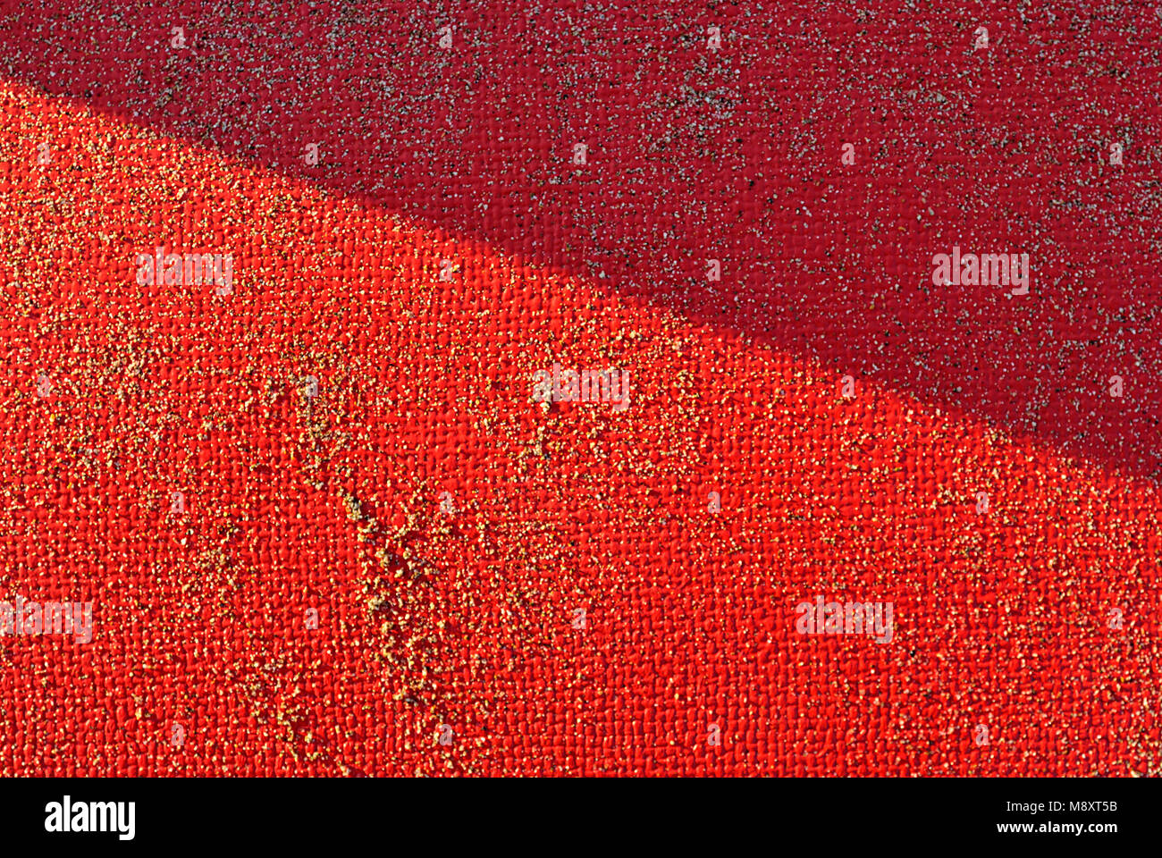 summer sea, red background for summer holidays, sand grains scattered ...