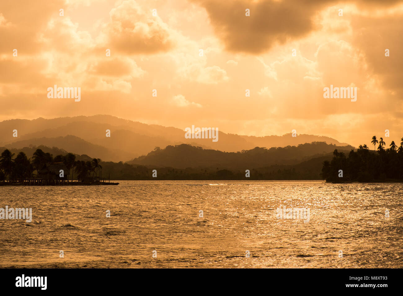 scenic sunset sky above palm tree island landscape Stock Photo - Alamy