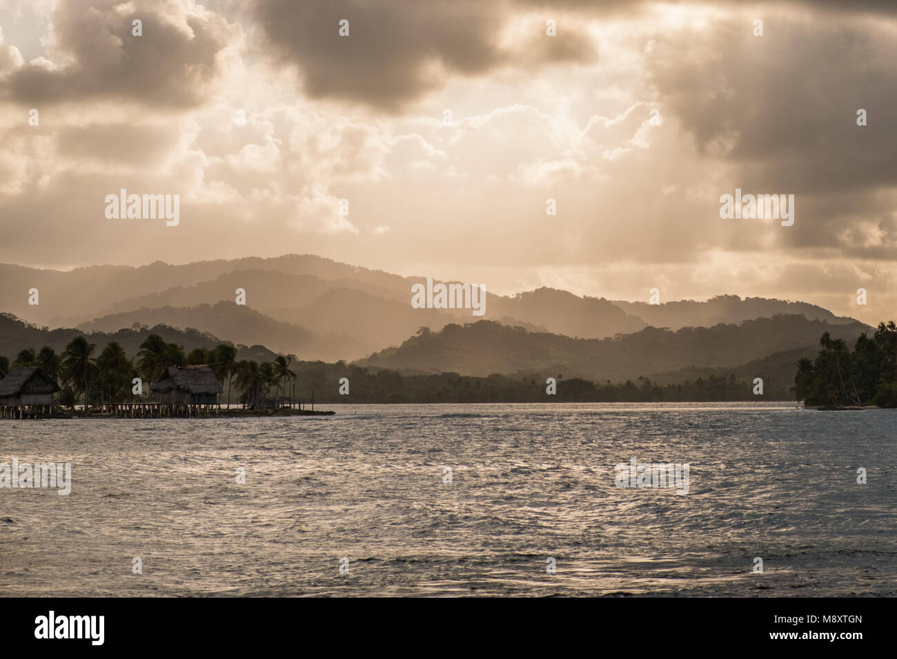 scenic sunset sky above palm tree island landscape Stock Photo - Alamy
