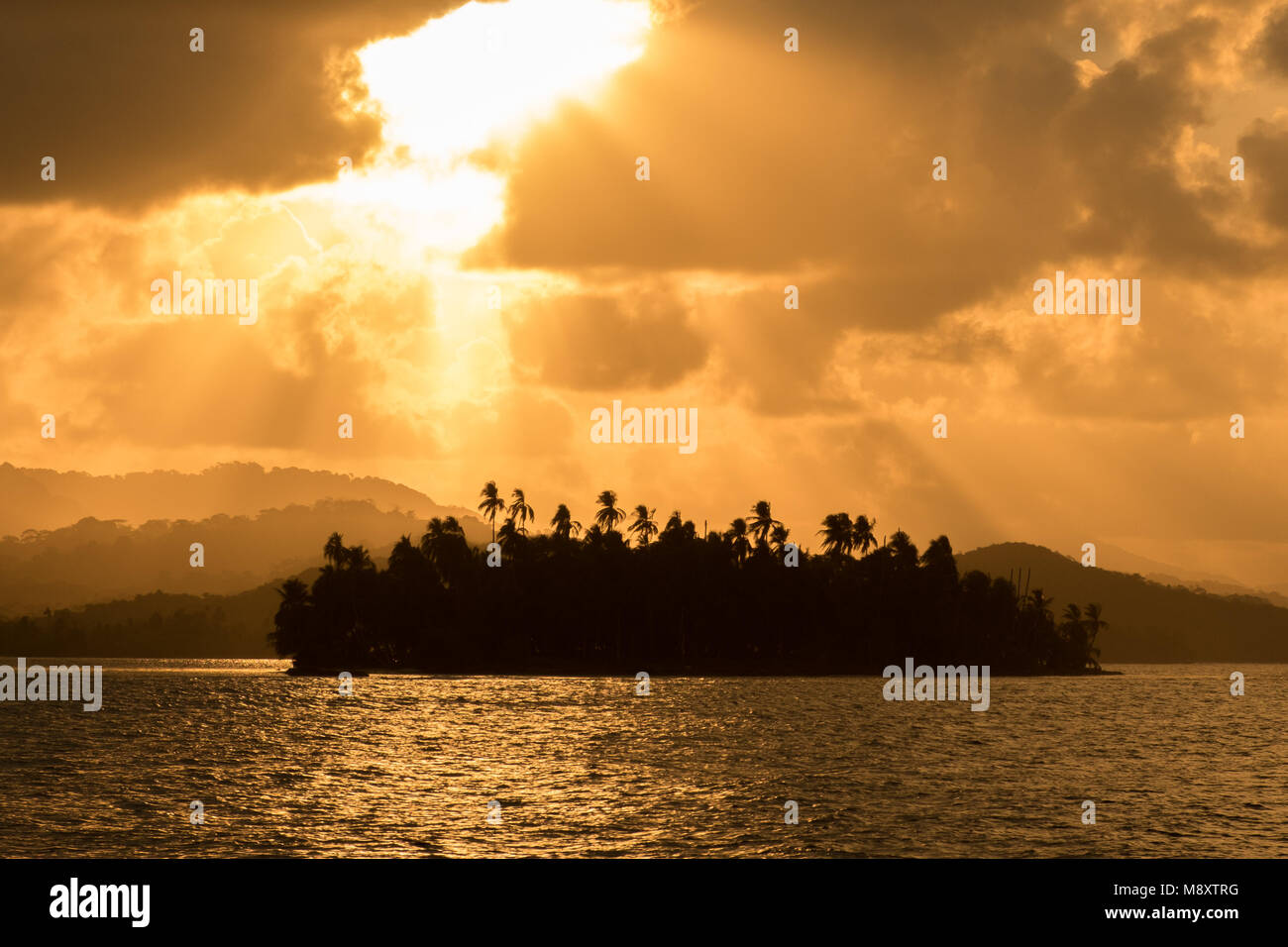 scenic sunset sky above palm tree island landscape Stock Photo - Alamy