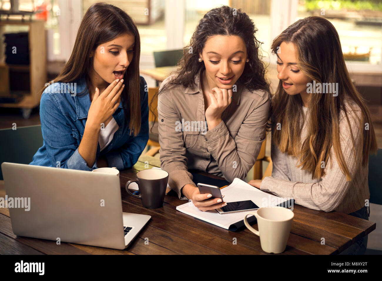 Group of girls making a pause on the studies for some gossip Stock ...