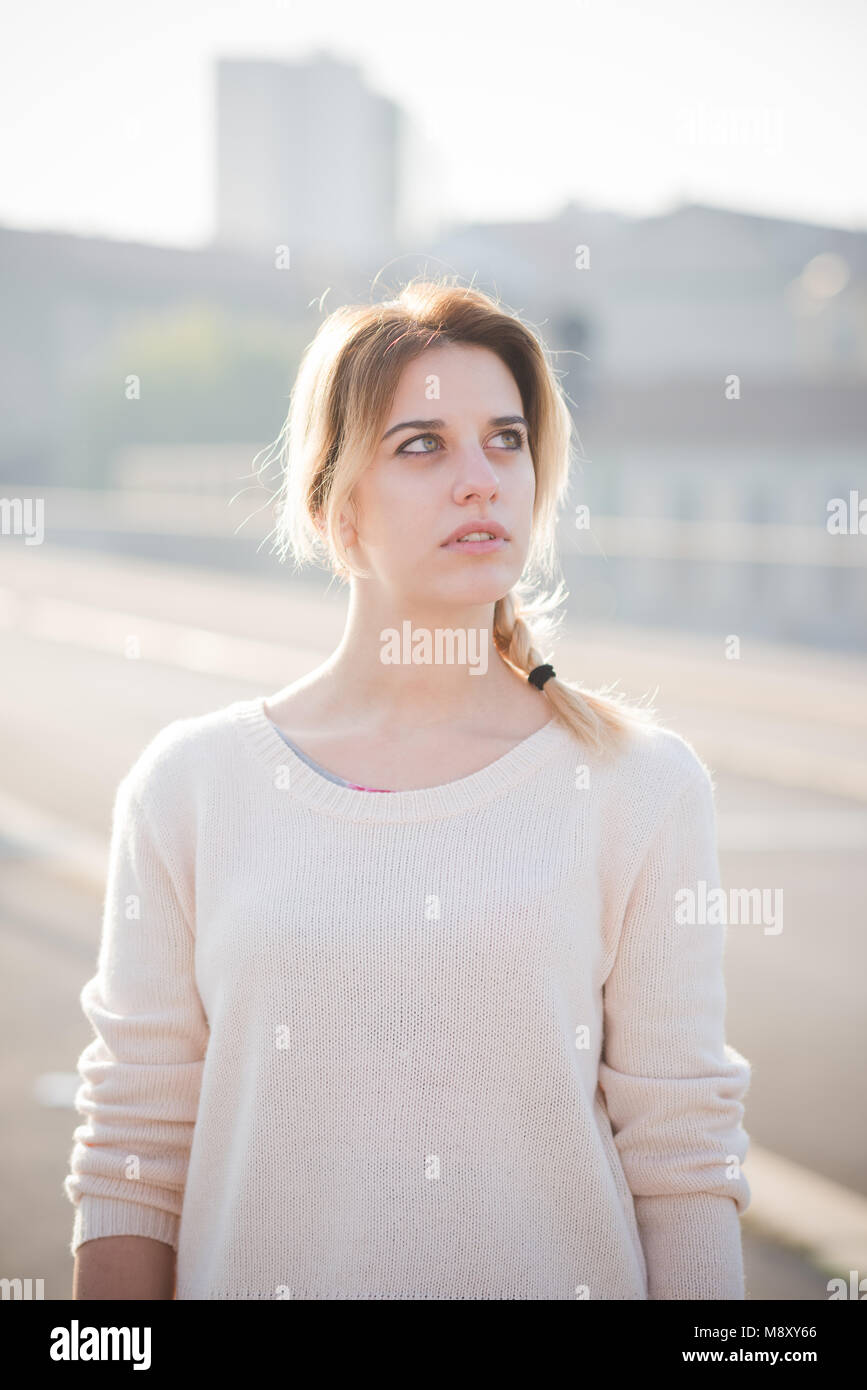 young woman looking away back light outdoor - determination, confidence ...