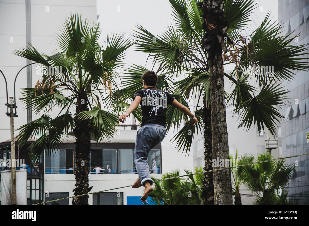 Man on rope jumping and doing balance Stock Photo - Alamy