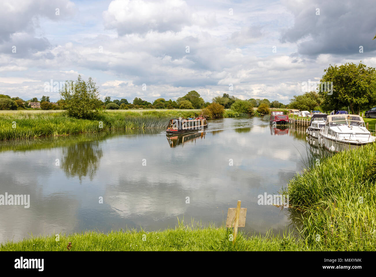 Converted Canal Barge making its way down stream on the River Thames ...