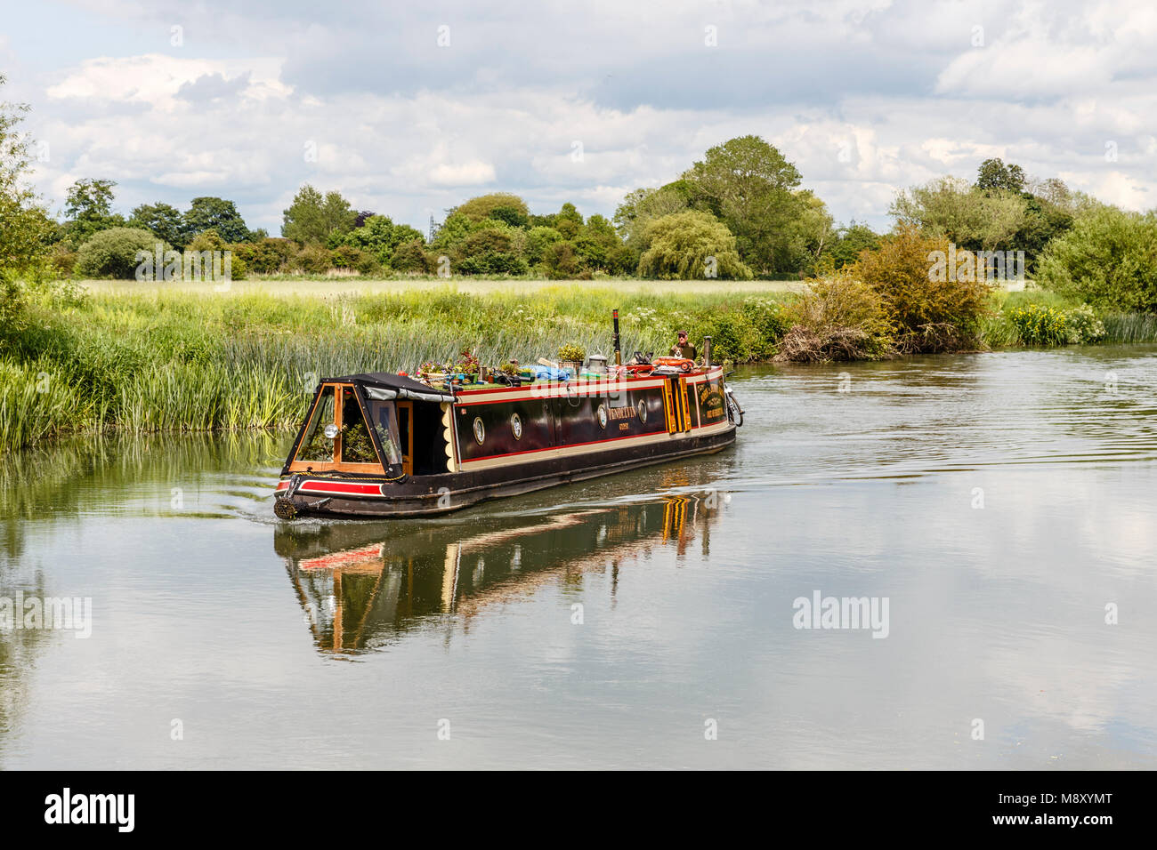 Converted Canal Barge making its way down stream on the River Thames ...