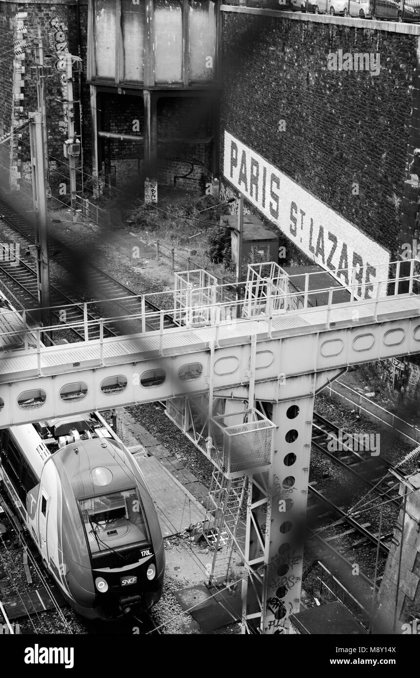 Train passing under bridge in Paris Stock Photo - Alamy