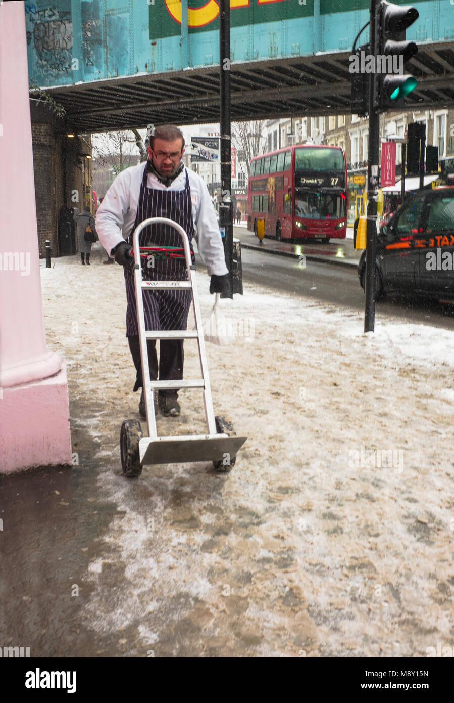 Trader pushing barrow through snow hi-res stock photography and images ...