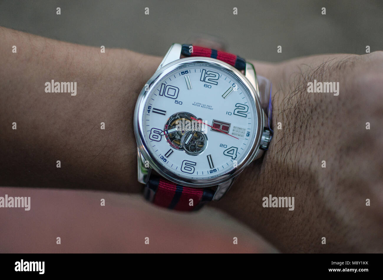 It's a bit late ! A hand and a watch Stock Photo - Alamy