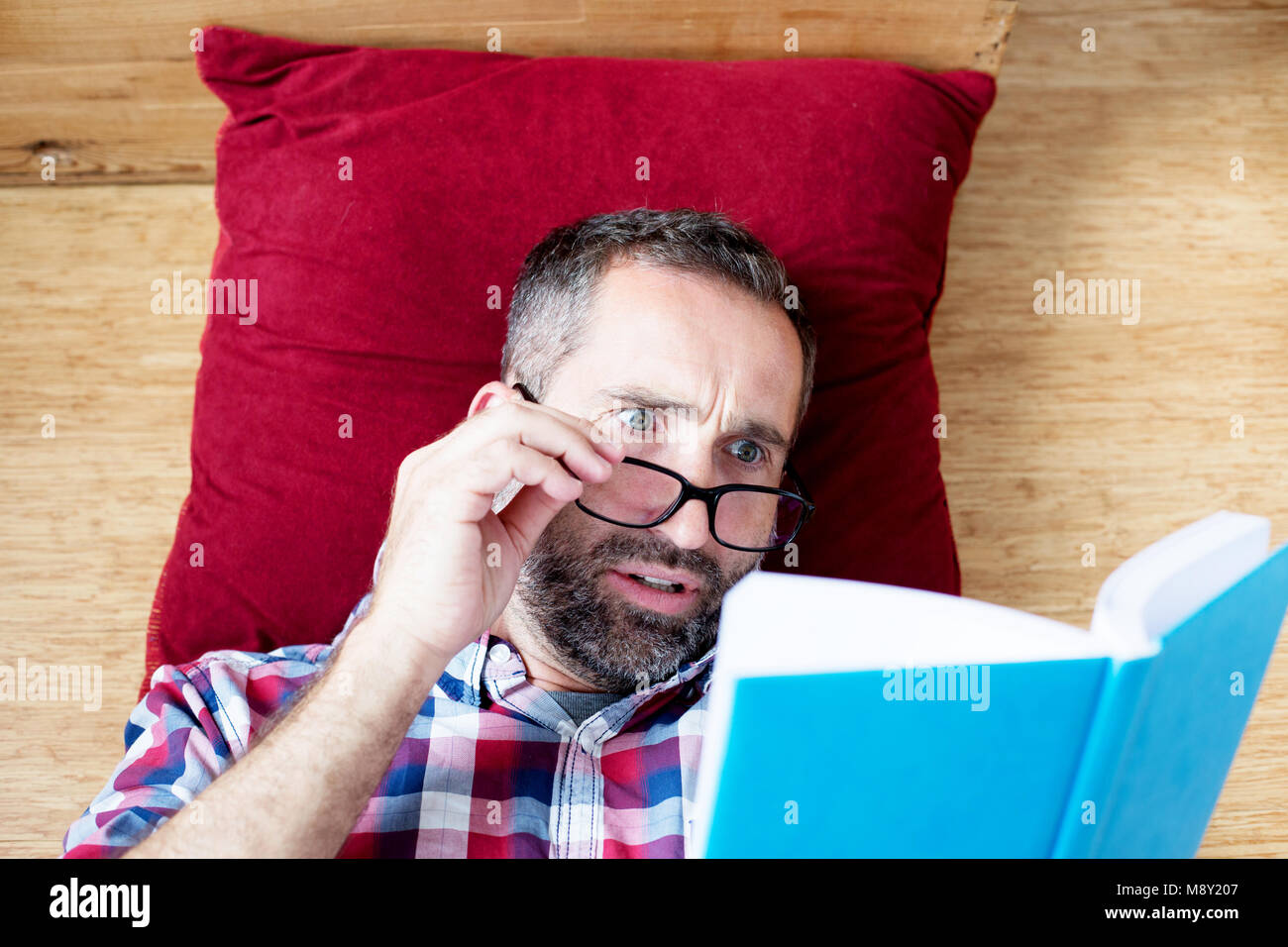 portrait of handsome bearded man reading a book Stock Photo - Alamy