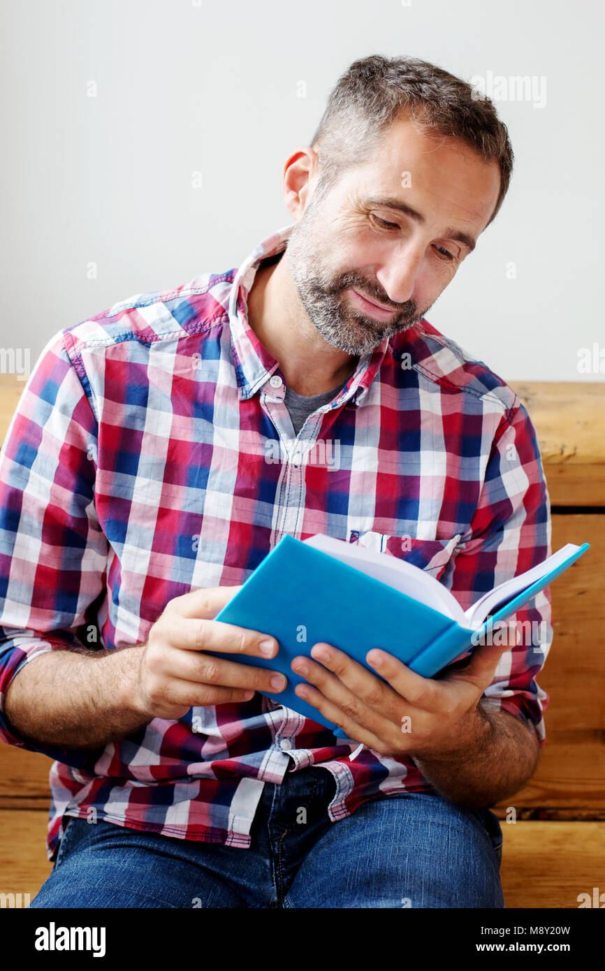 portrait of handsome bearded man reading a book Stock Photo - Alamy