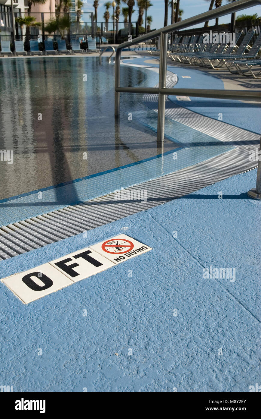 Shallow swimming pool with no diving allowed Stock Photo - Alamy