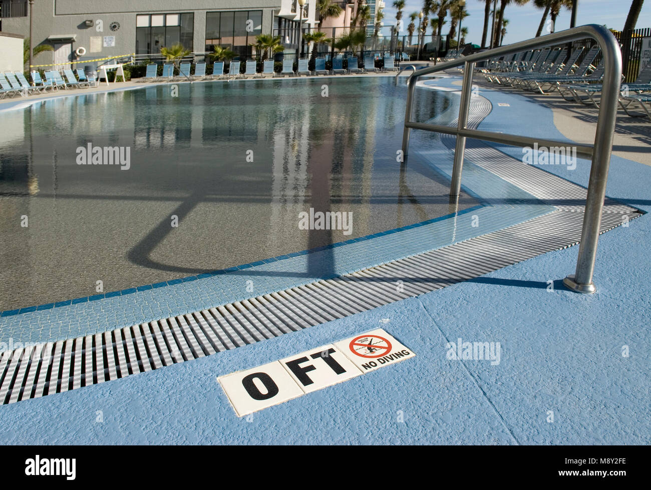 Shallow swimming pool with no diving allowed Stock Photo - Alamy