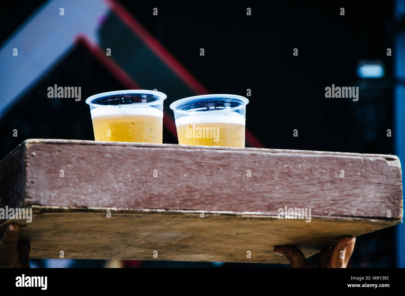 Two plastic cups with beer in a wooden box Stock Photo - Alamy