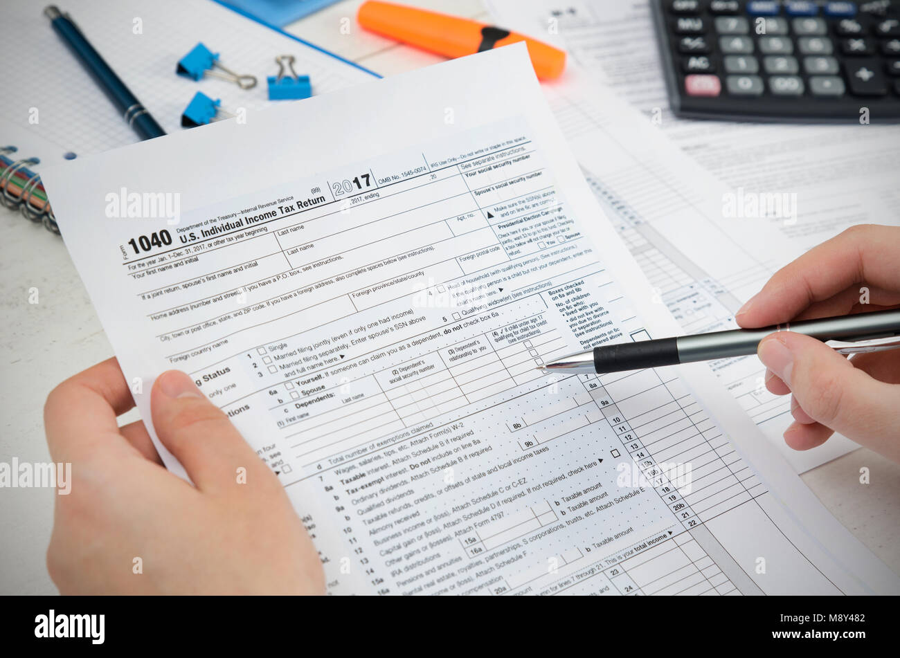 Man filling US tax form. tax form us business income office hand fill ...