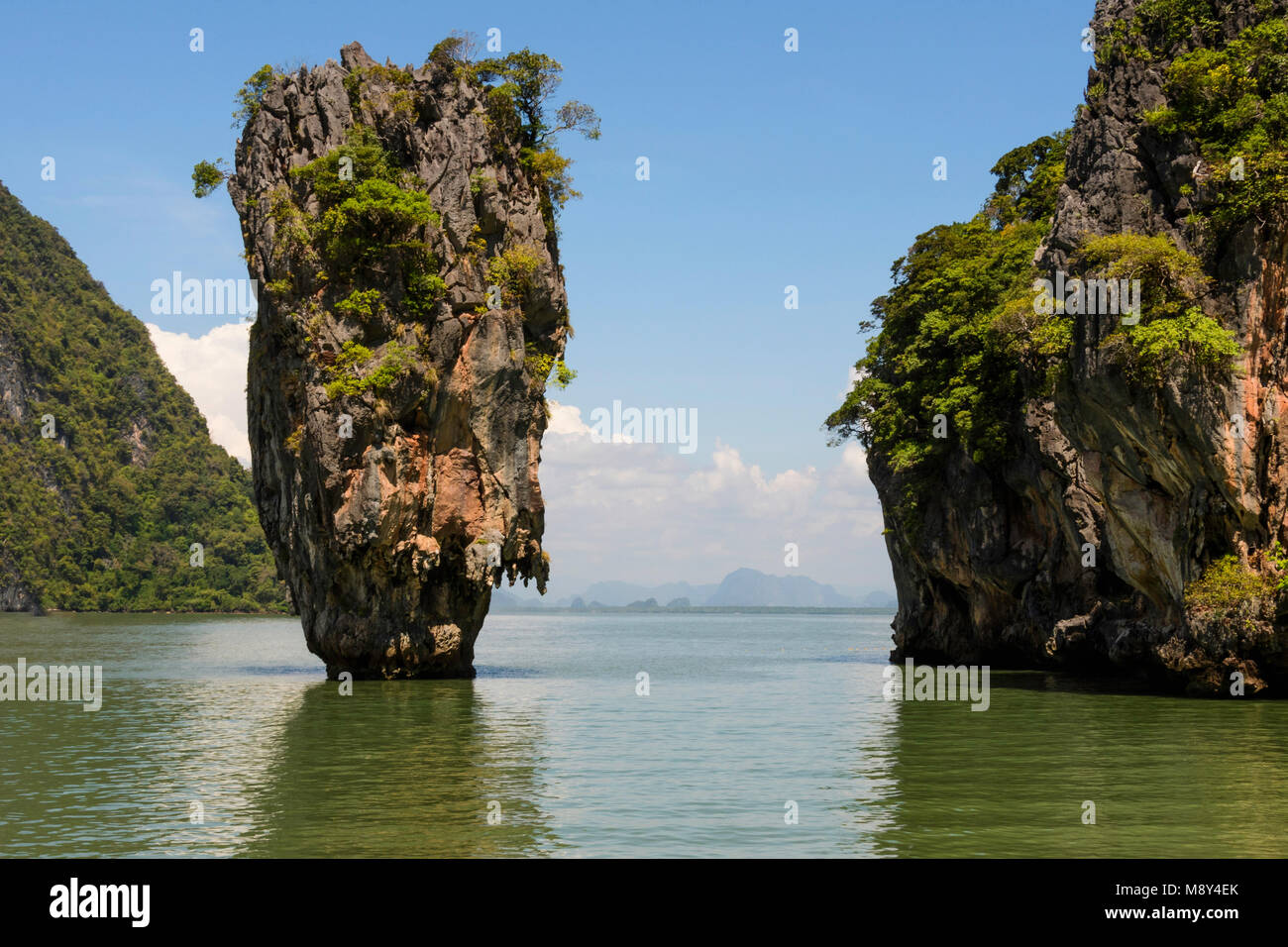 Vertical islet of Ko Tapu limestone eroded by the sea twenty meters ...
