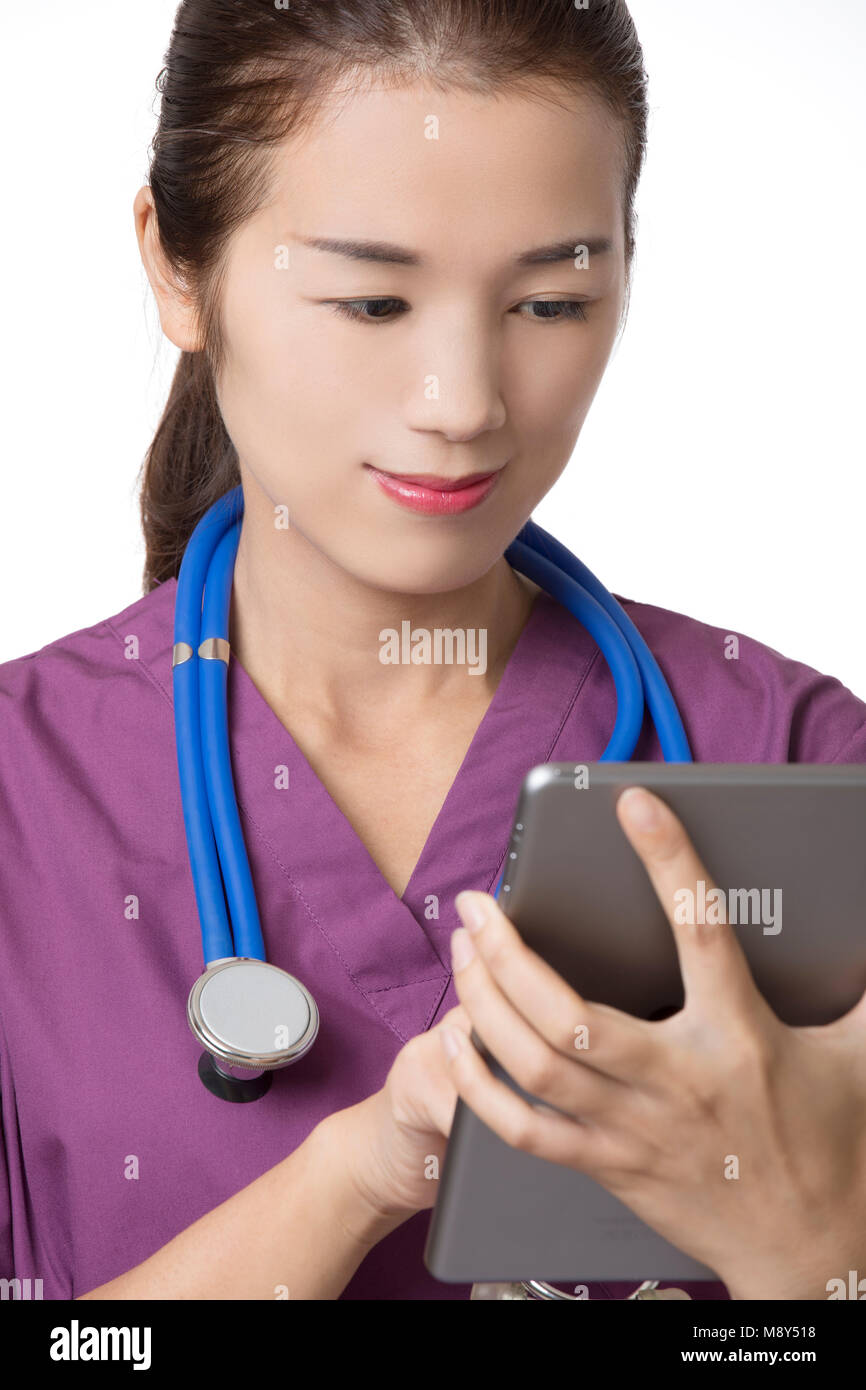 Beautiful Asian American doctor or nurse using a tablet computer with ...