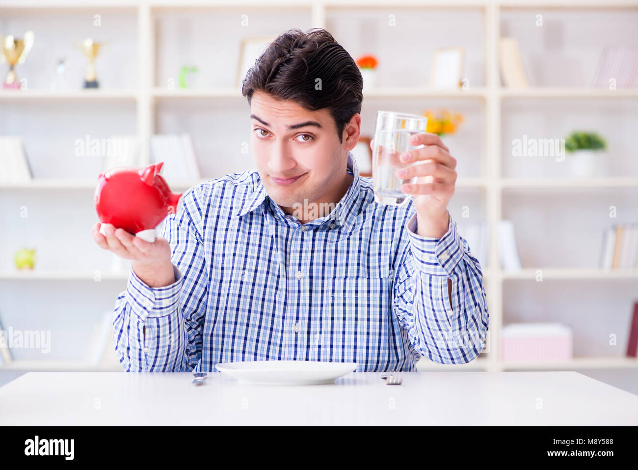Man running out of money in restaurant and using savings from piggy ...