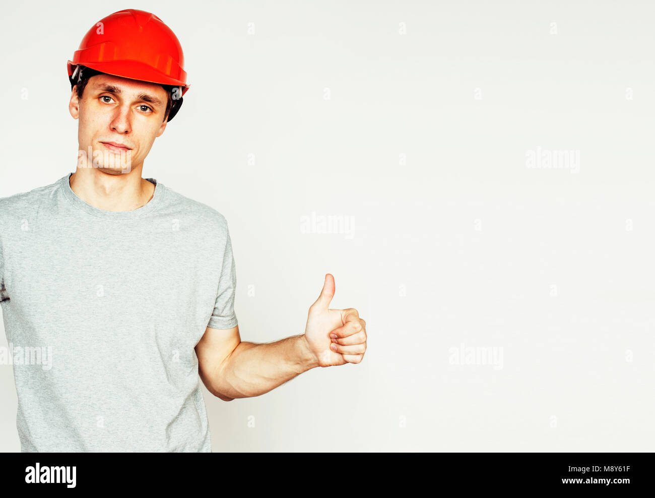 young real hard worker man isolated on white background on ladde Stock ...