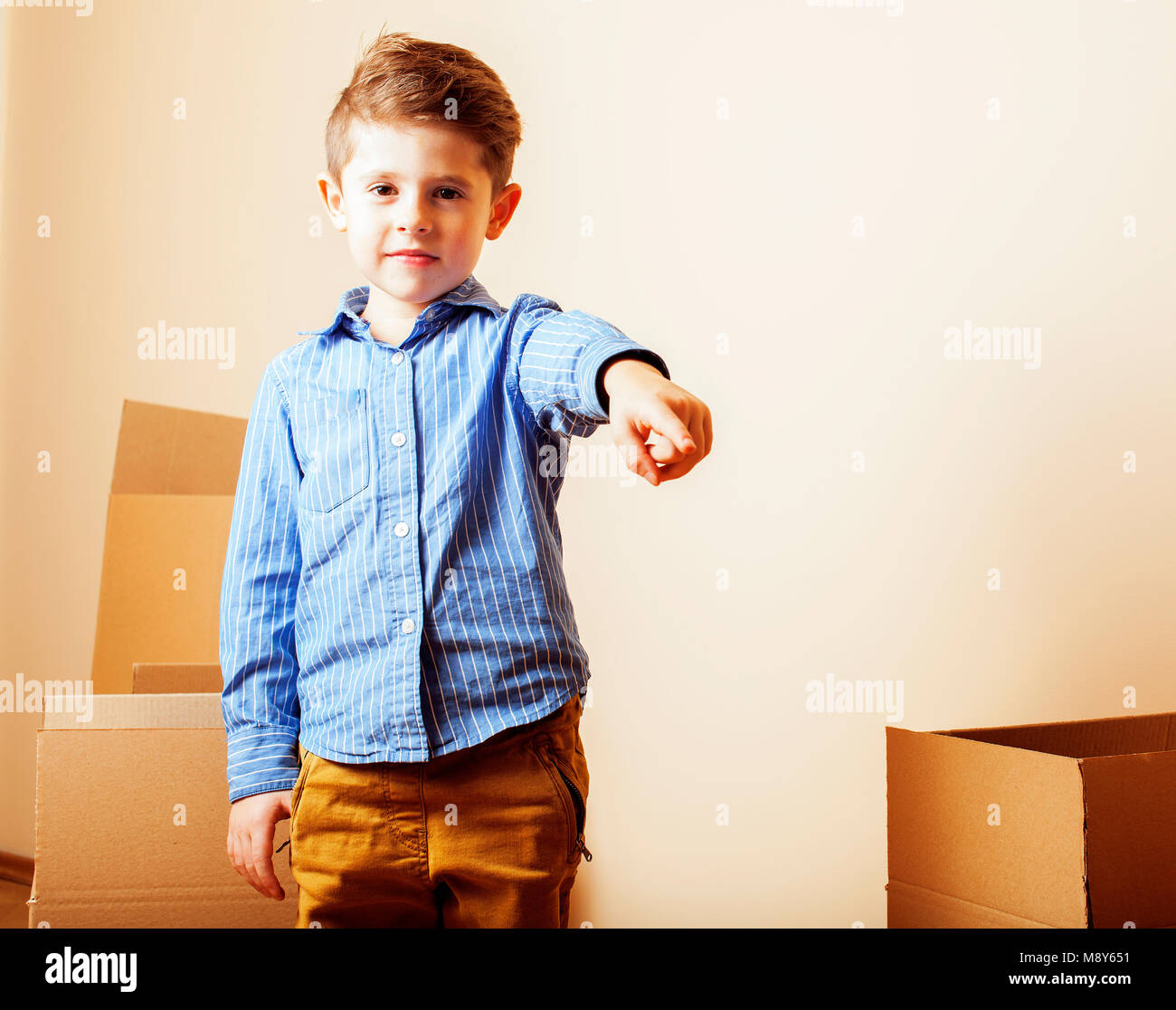 little cute boy in empty room, remoove to new house. home alone Stock ...
