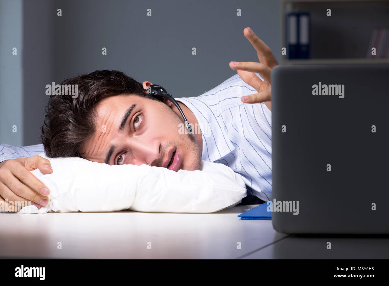 Tired and exhausted helpdesk operator during night shift Stock Photo ...