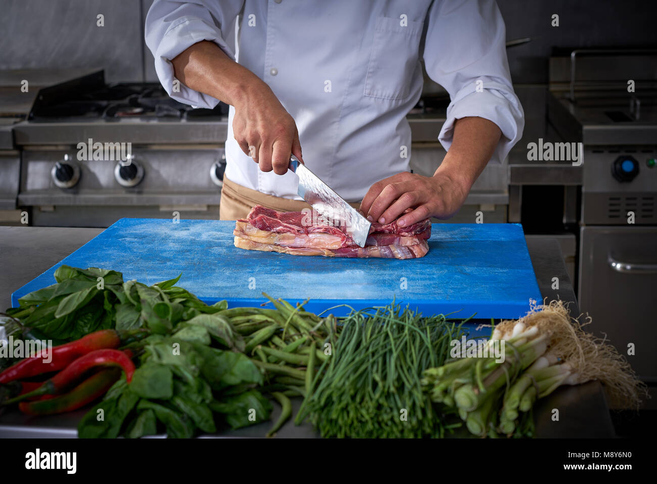 Chef hands cutting meat in restaurant kitchen of stainless steel Stock ...
