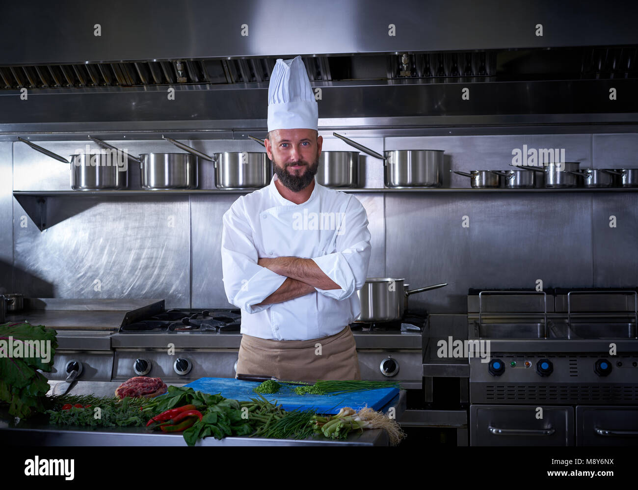 Chef portrait with beard in restaurant kitchen with crossed arms Stock ...