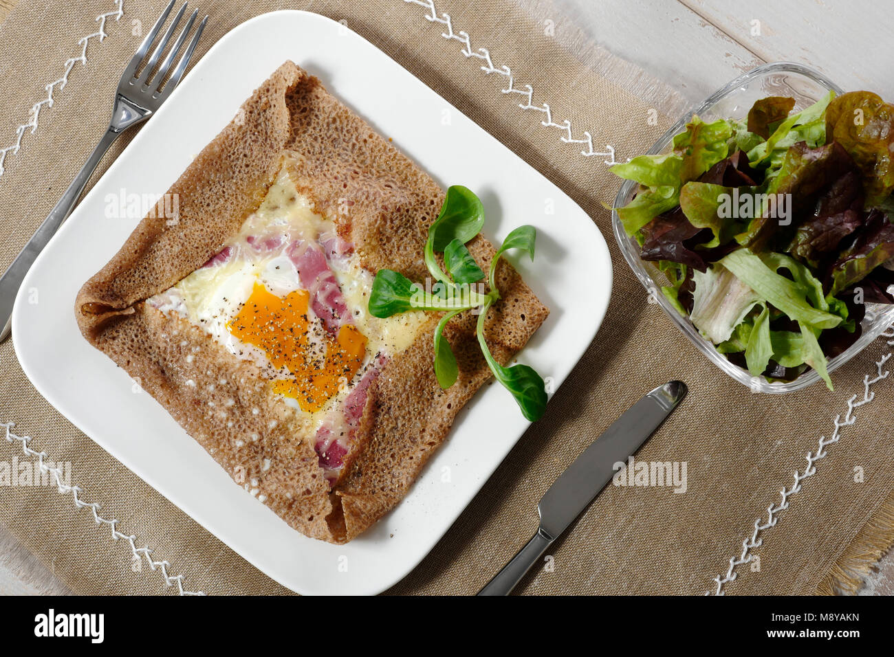 Breton crepe with egg in a white plate Stock Photo - Alamy