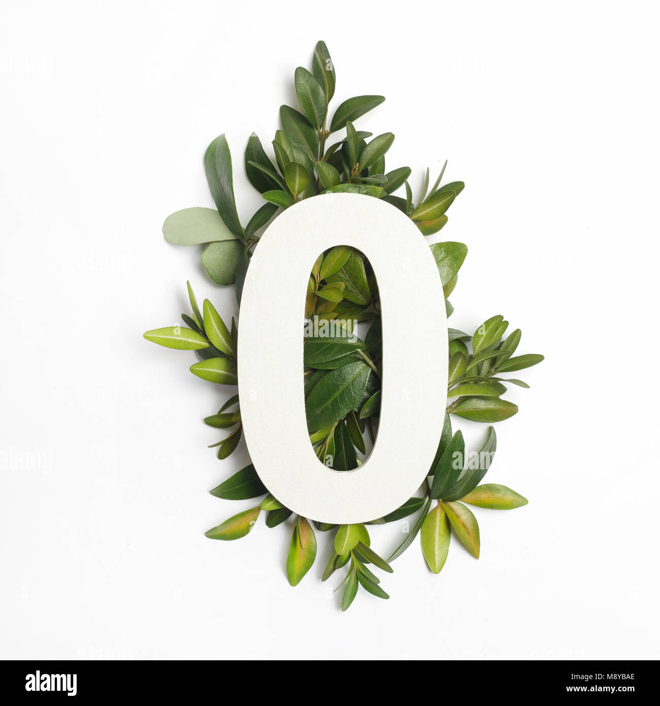 Number zero shape with green leaves. Nature concept. Flat lay Stock ...