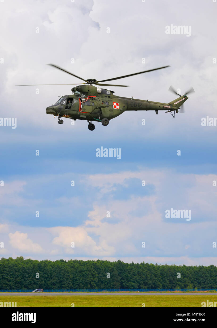 The Polish Air Force PZL W-3 Sokol (Falcon) flying over meadow during ...