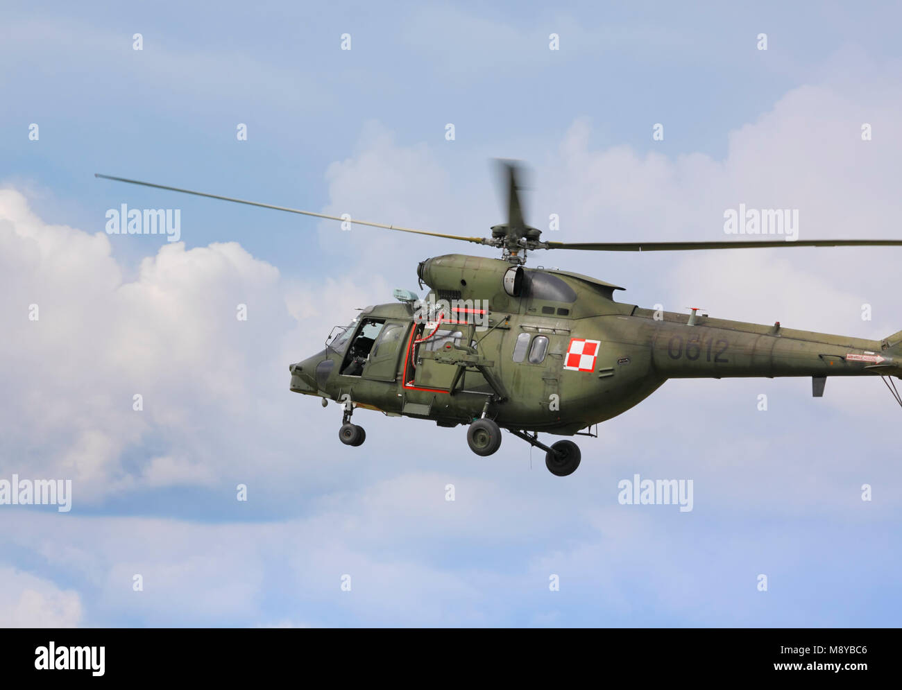 The Polish Air Force PZL W-3 Sokol (Falcon) flying over cloudy sky ...